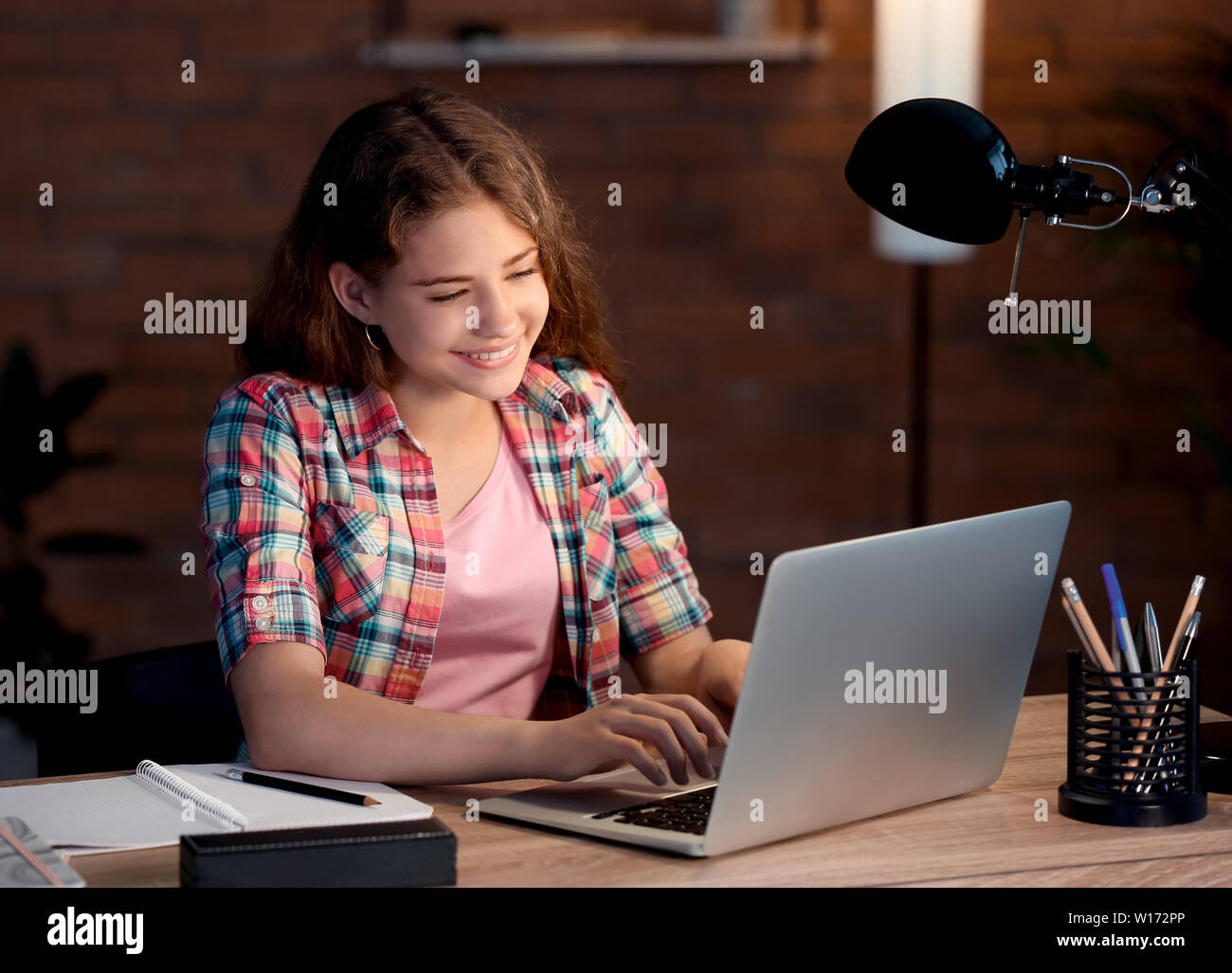 Teenage girl doing homework late in evening Stock Photo - Alamy