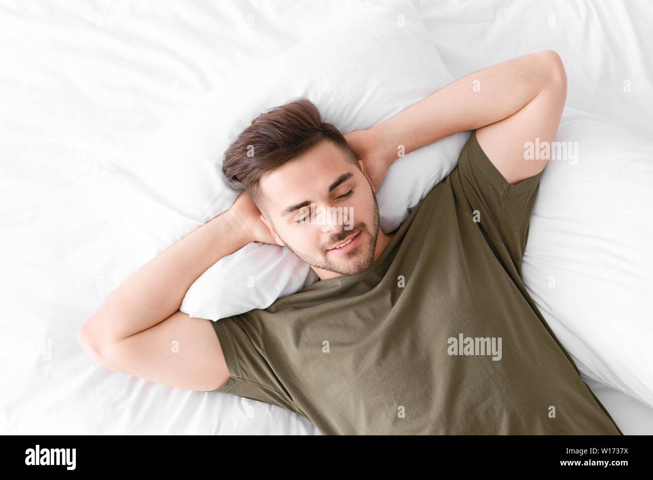 Handsome man sleeping in bed at home Stock Photo - Alamy