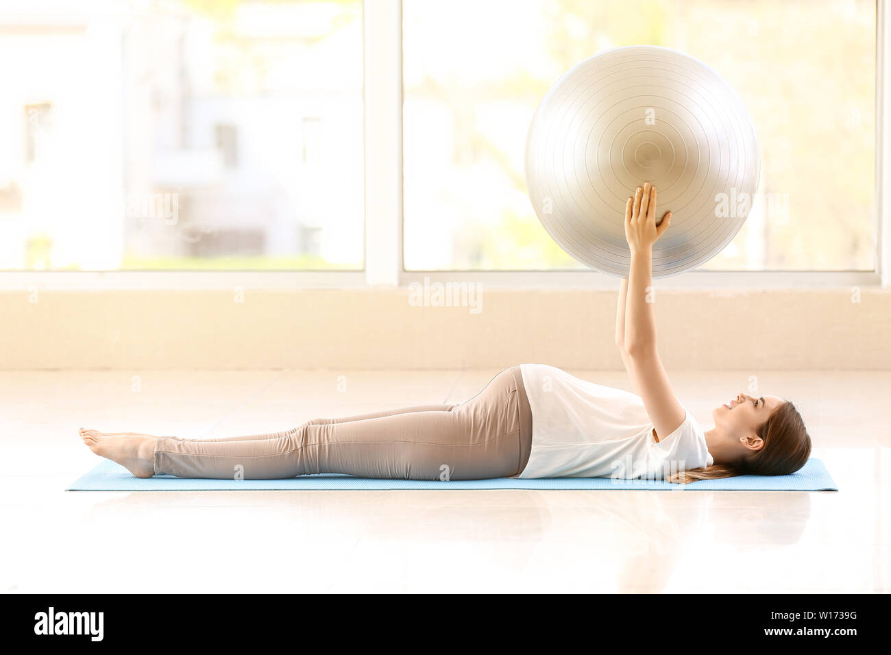Beautiful pregnant woman with fitball training in gym Stock Photo - Alamy