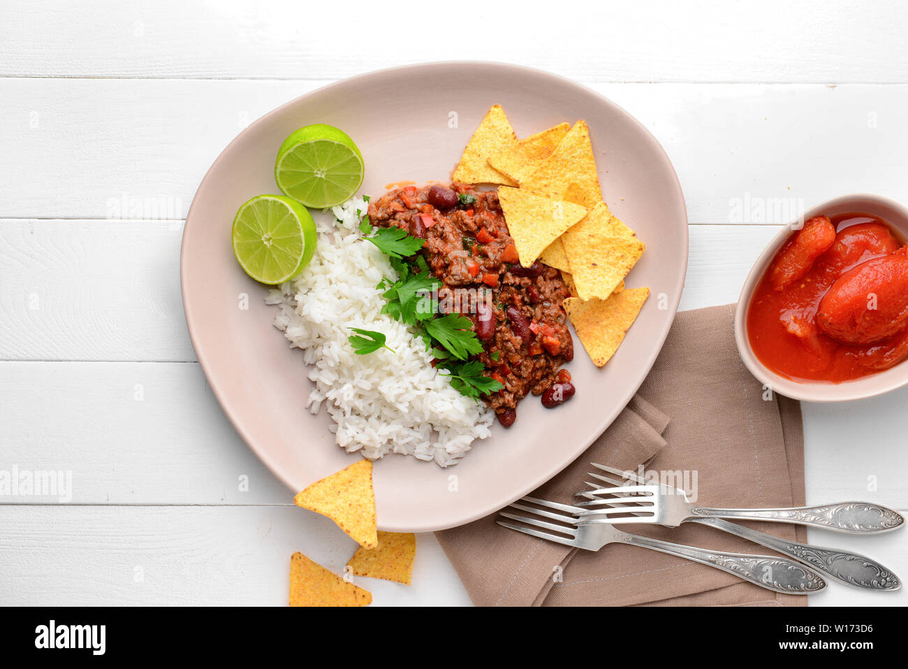 Plate with tasty chili con carne and rice on white table Stock Photo ...