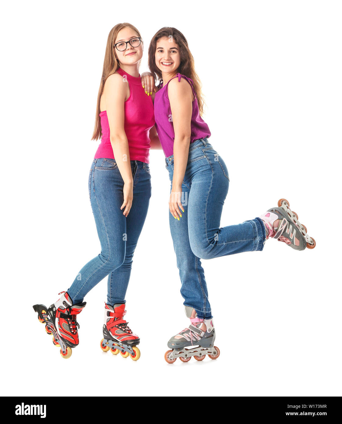 Teenage girls on roller skates against white background Stock Photo - Alamy