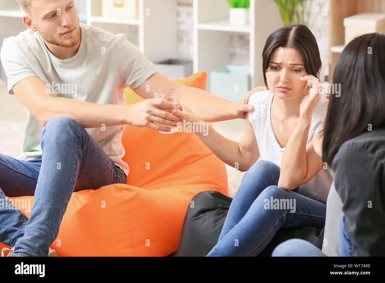 People calming woman at group therapy session Stock Photo - Alamy