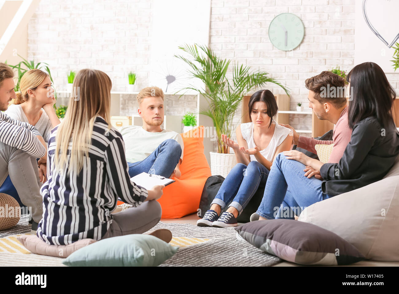 People calming woman at group therapy session Stock Photo - Alamy