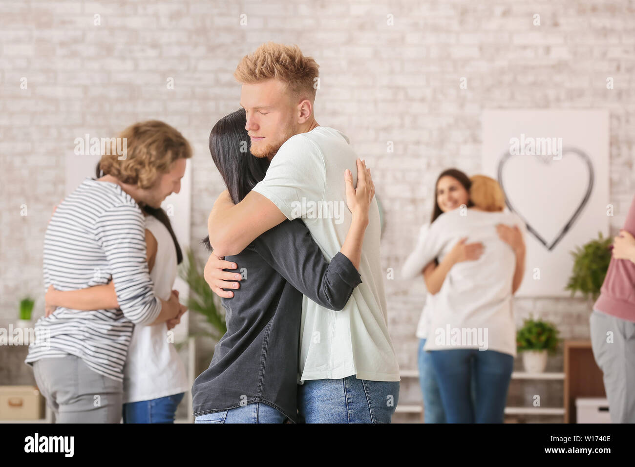 People hugging at group therapy session Stock Photo - Alamy