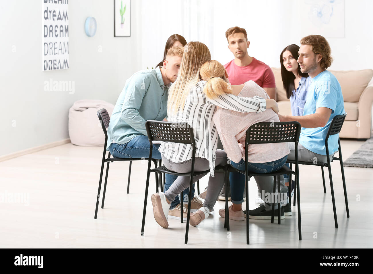People calming woman at group therapy session Stock Photo - Alamy