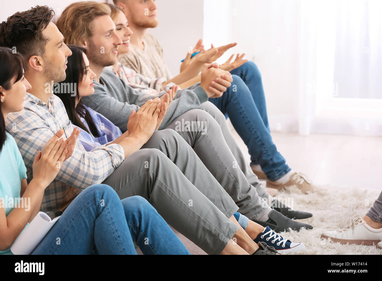 People clapping hands at group therapy session Stock Photo - Alamy