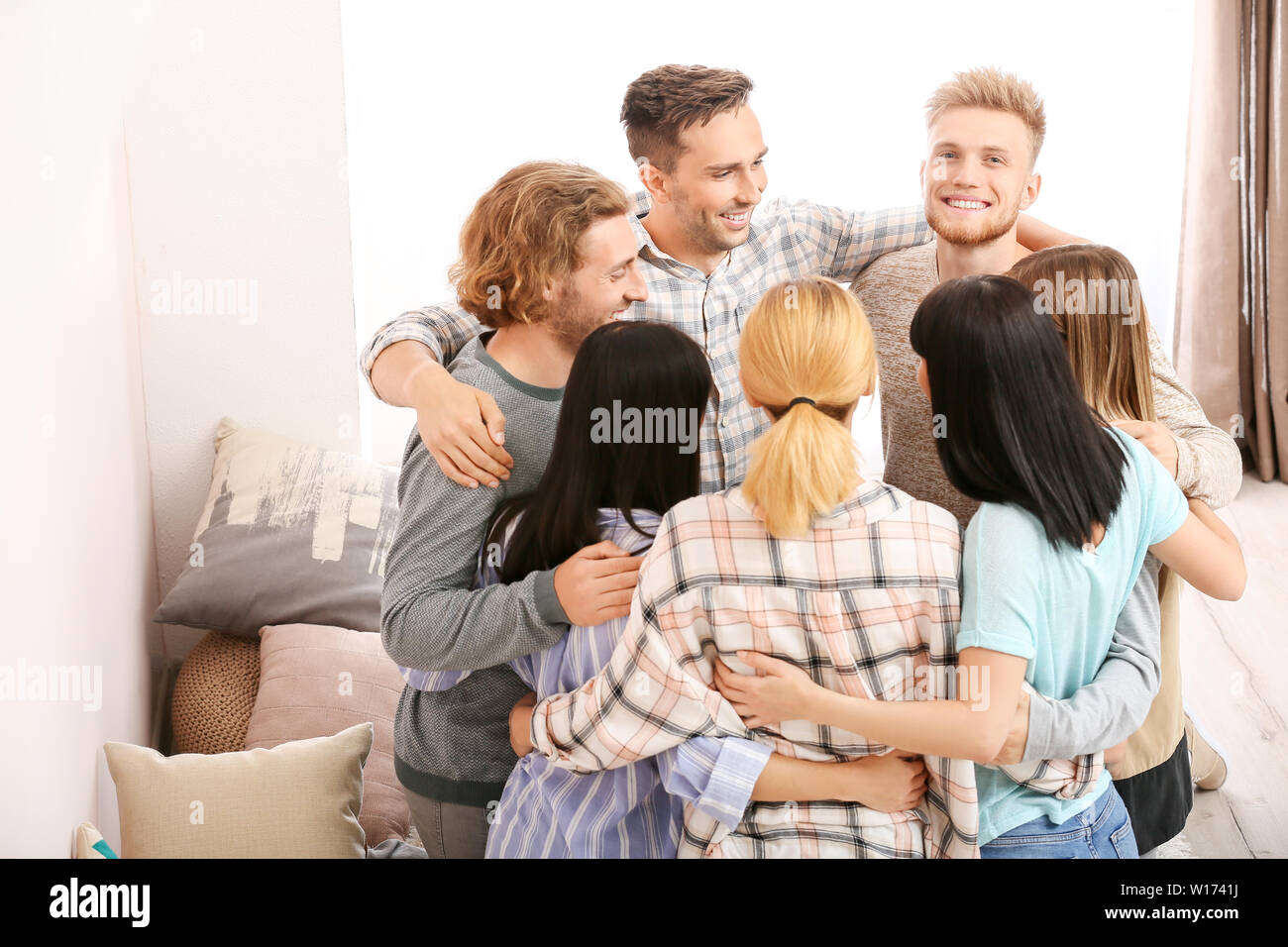 People hugging at group therapy session Stock Photo - Alamy