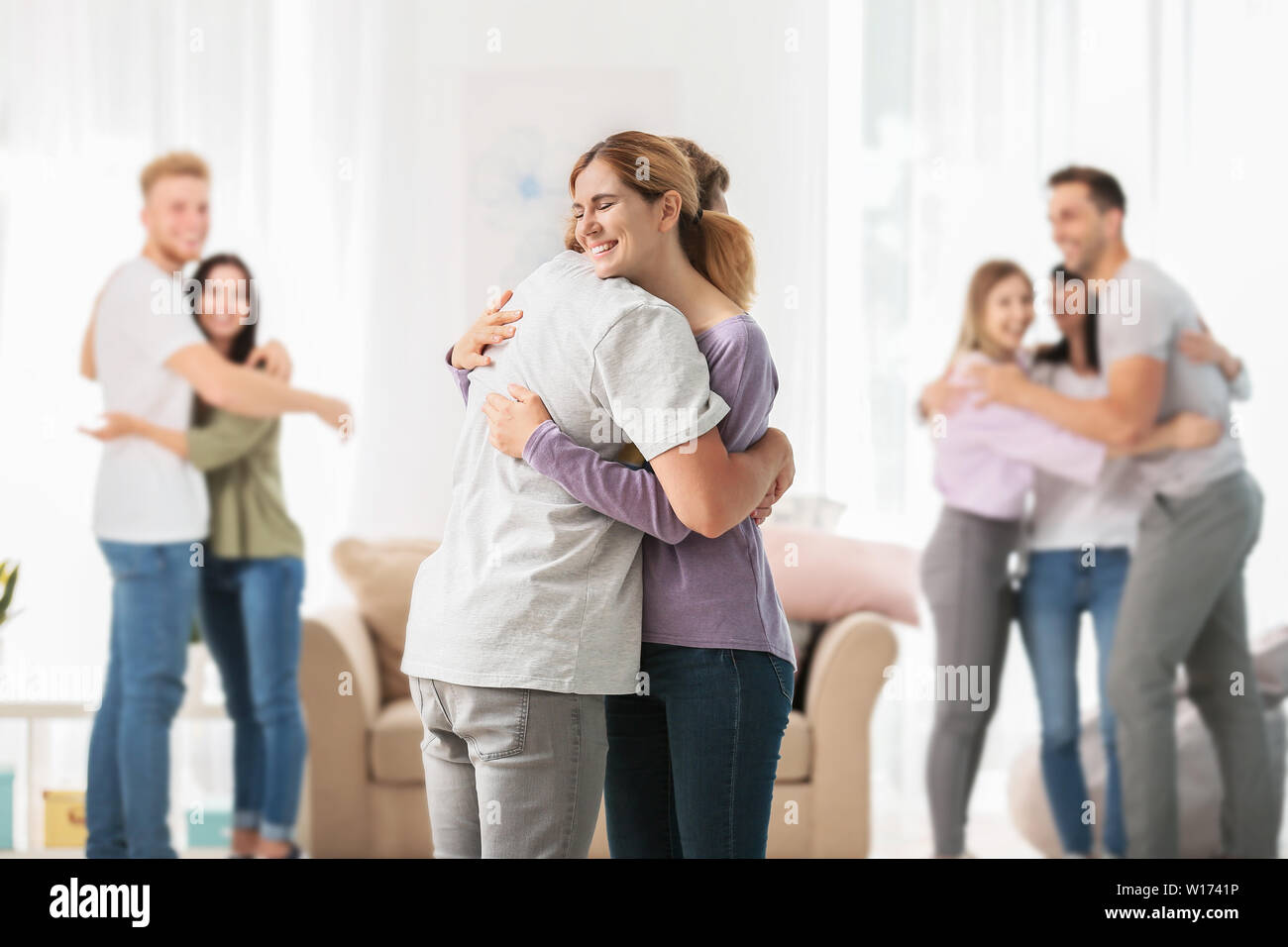 People hugging at group therapy session Stock Photo - Alamy