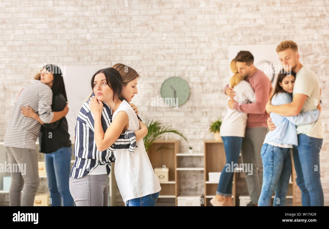 People hugging at group therapy session Stock Photo - Alamy