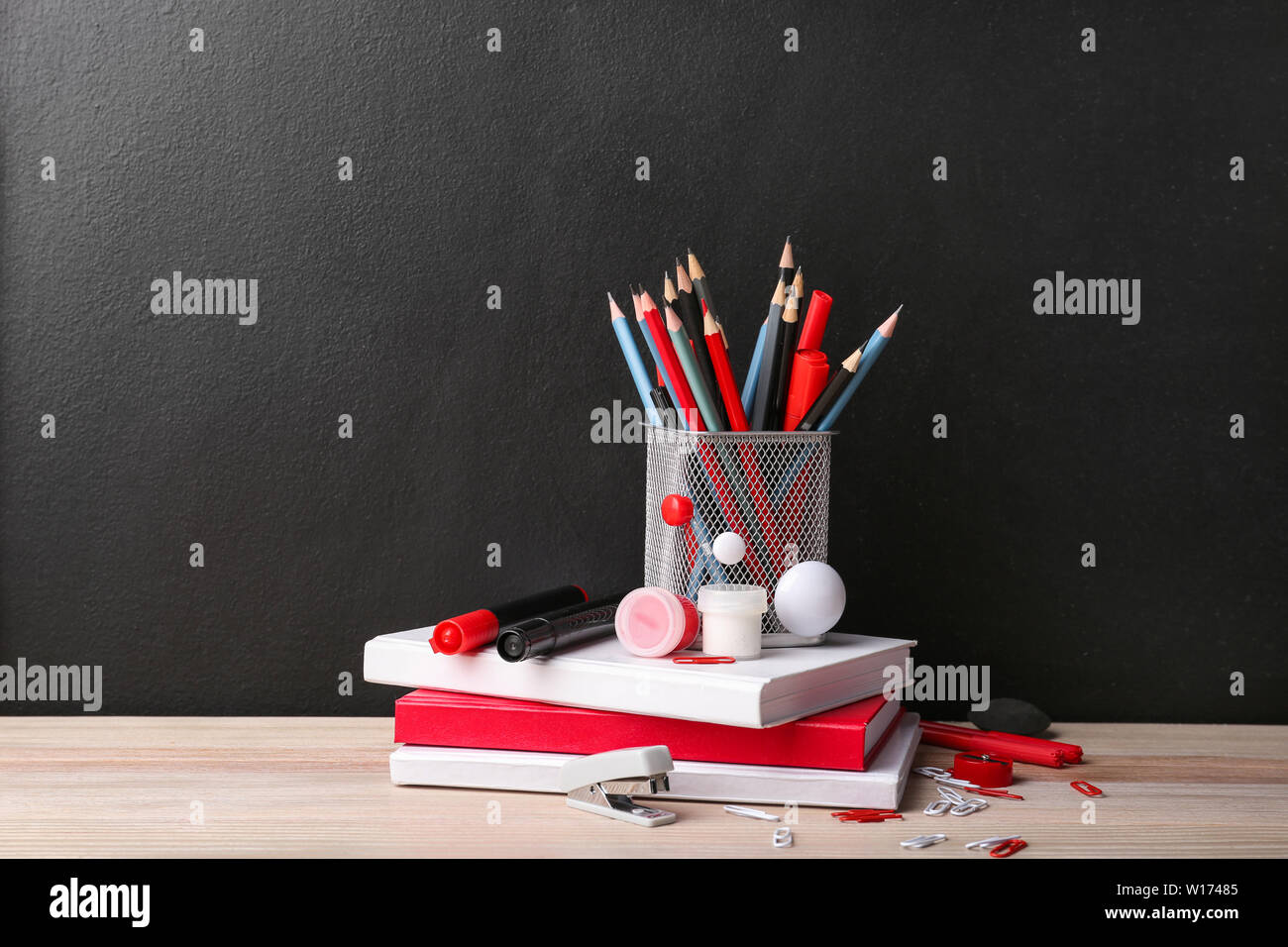 Set of school supplies on table in classroom Stock Photo - Alamy