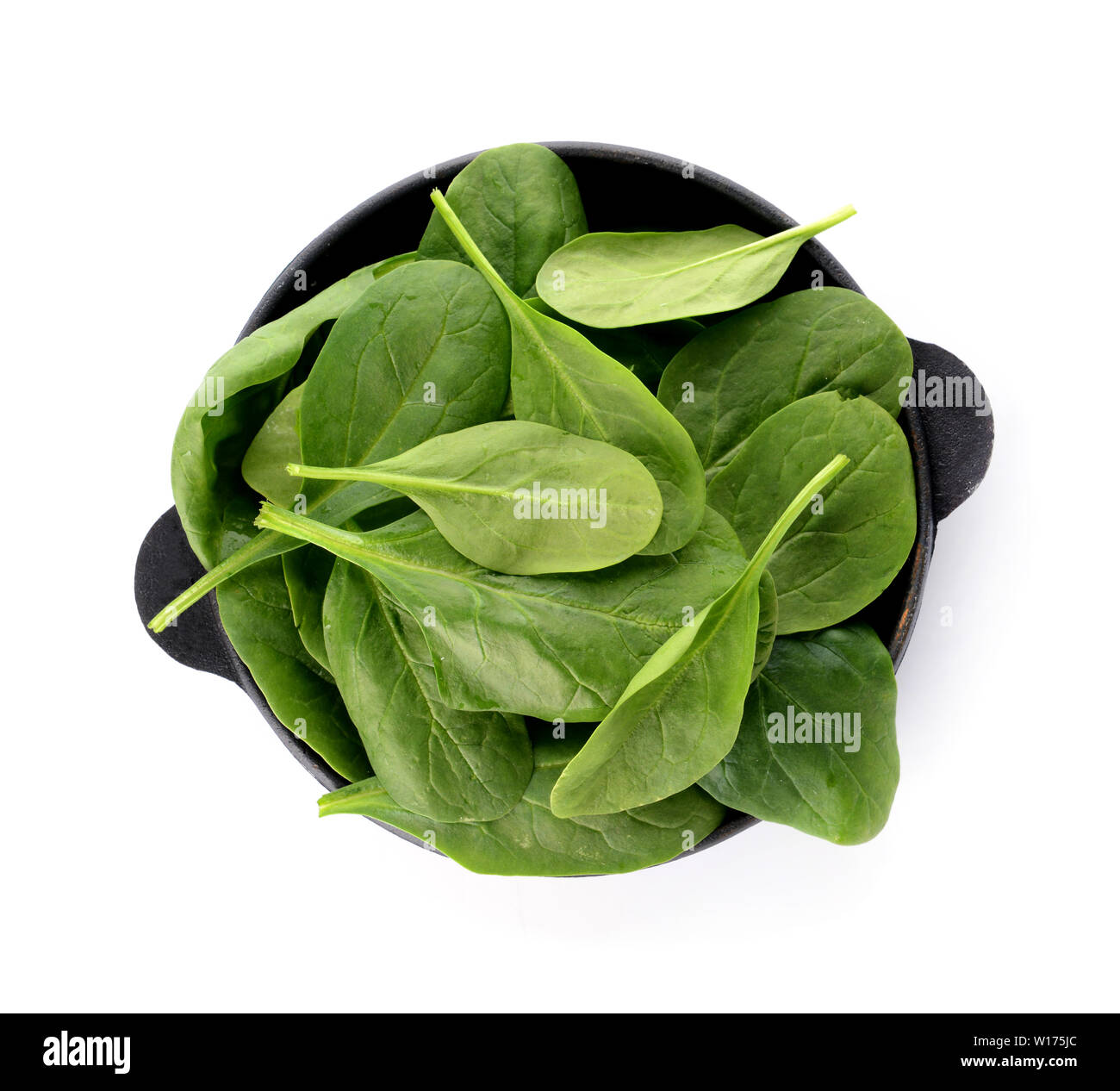 Frying pan with fresh spinach on white background Stock Photo - Alamy