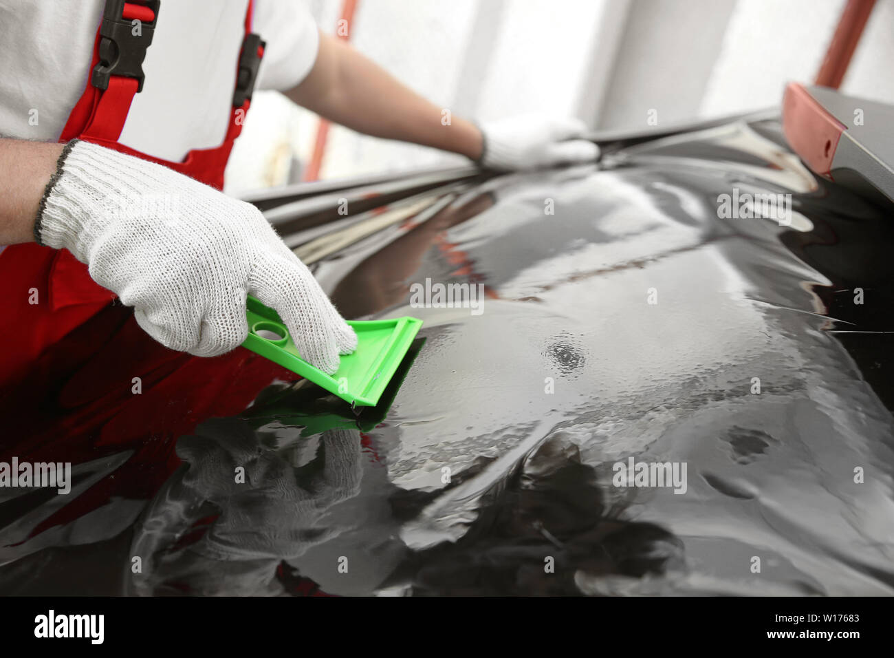Male worker tinting car window outdoors Stock Photo - Alamy