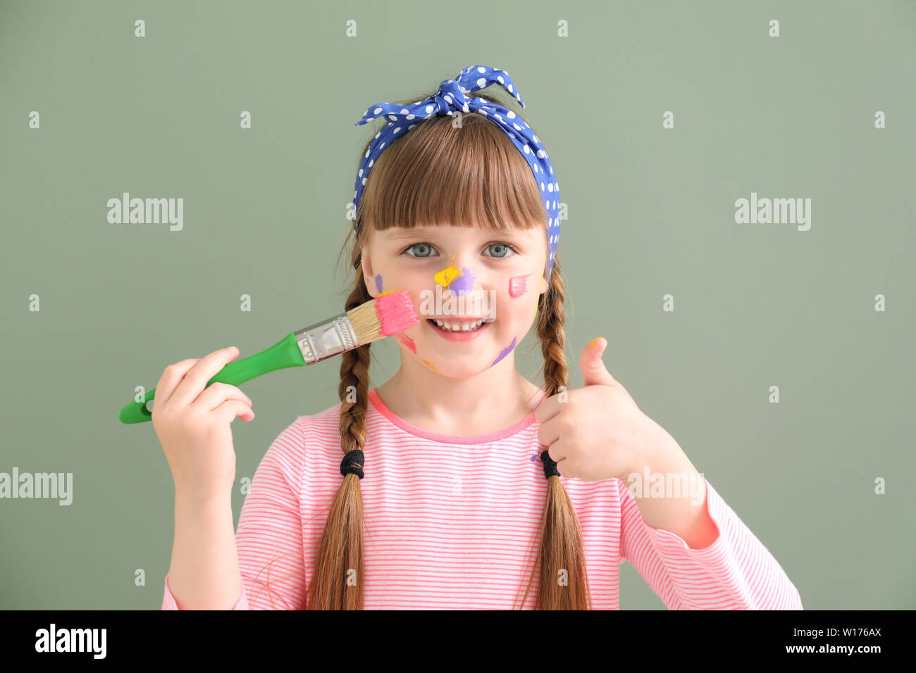 Cute little artist on color background Stock Photo - Alamy
