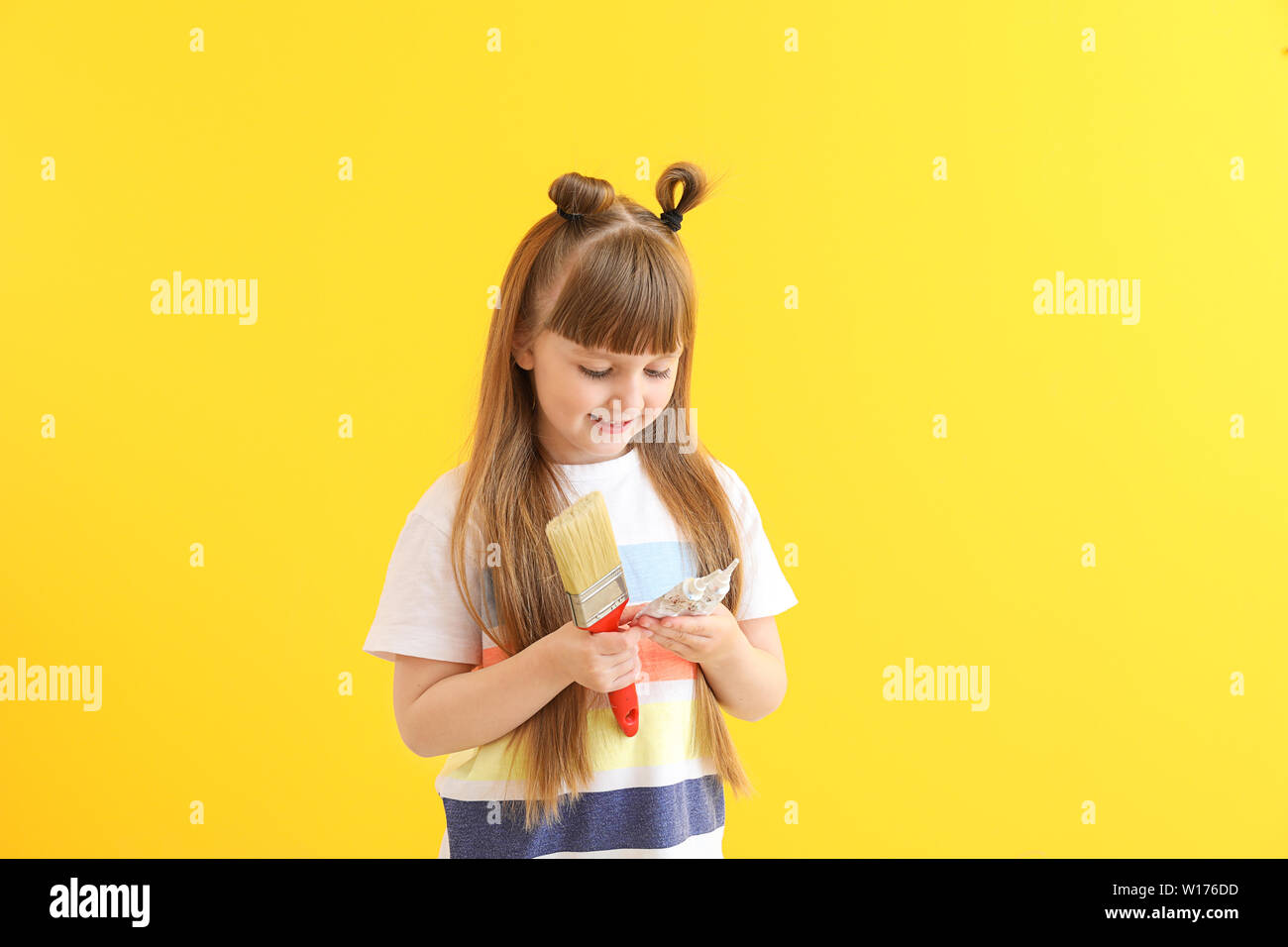 Cute little artist on color background Stock Photo - Alamy