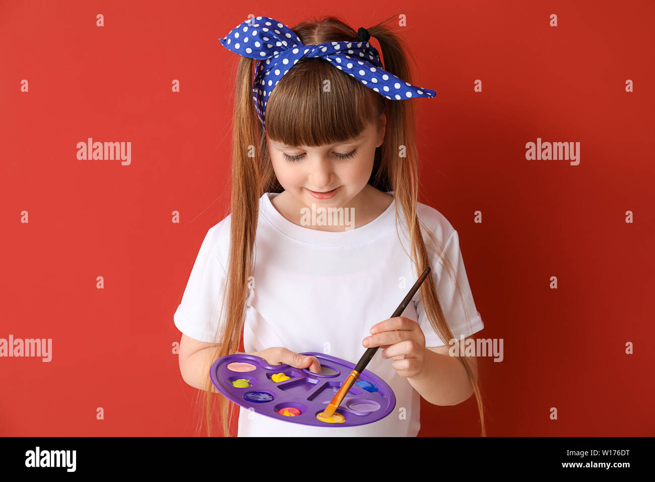 Cute little artist on color background Stock Photo - Alamy