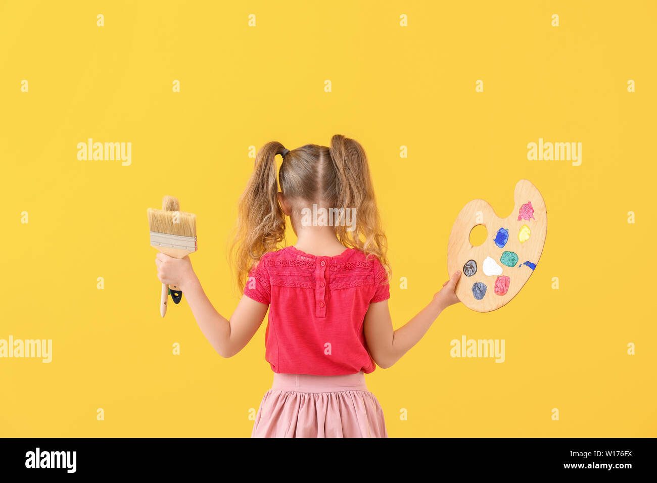Cute little artist on color background Stock Photo - Alamy