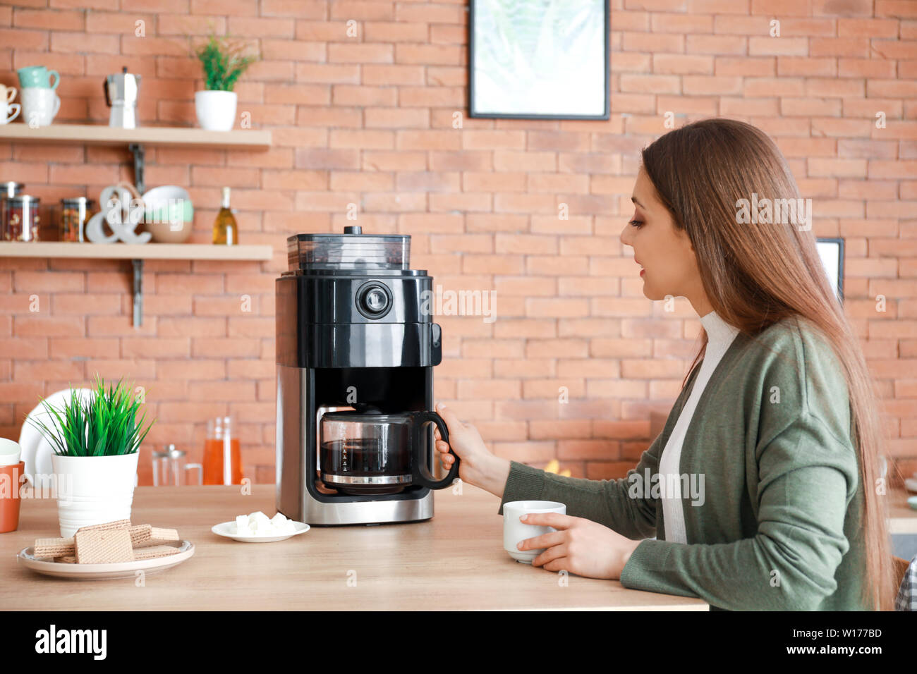 Woman using coffee machine hi-res stock photography and images - Alamy
