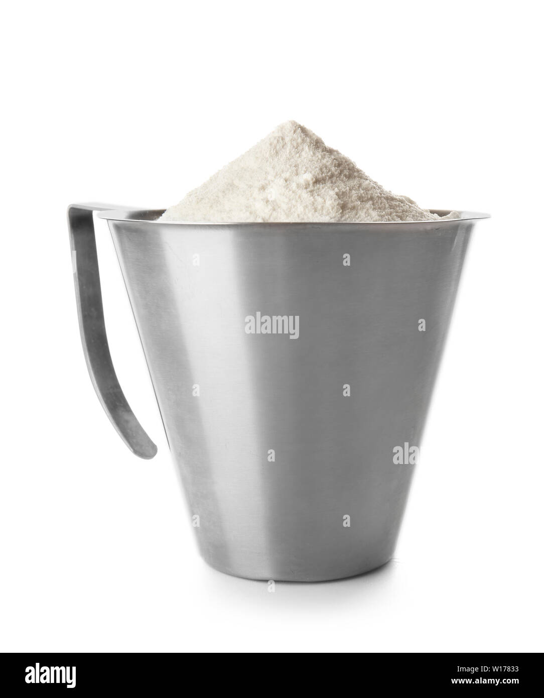 Measuring jug with flour on white background Stock Photo - Alamy