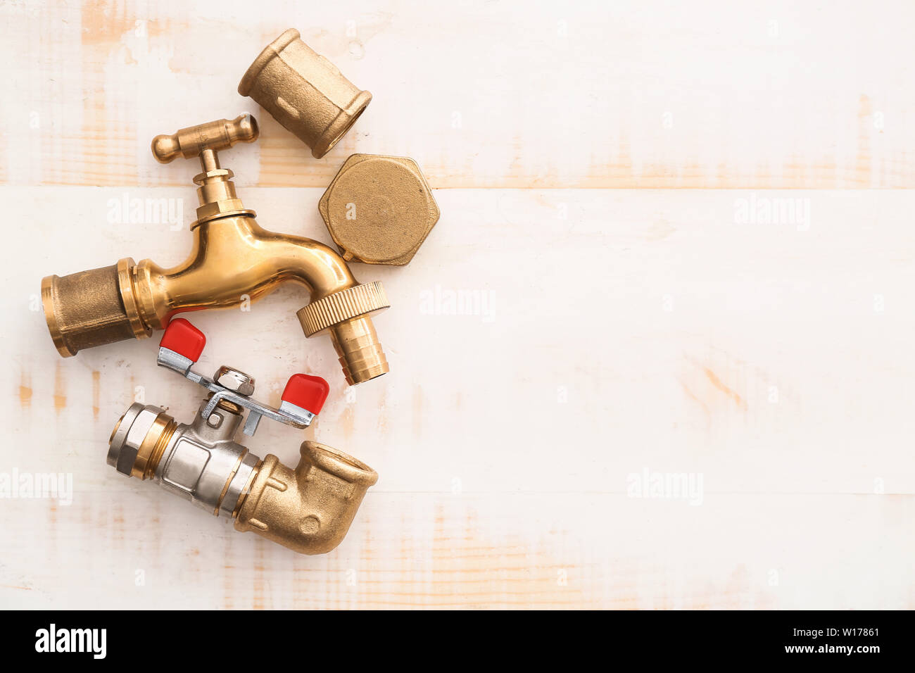 Set of plumbing items on white wooden background Stock Photo - Alamy