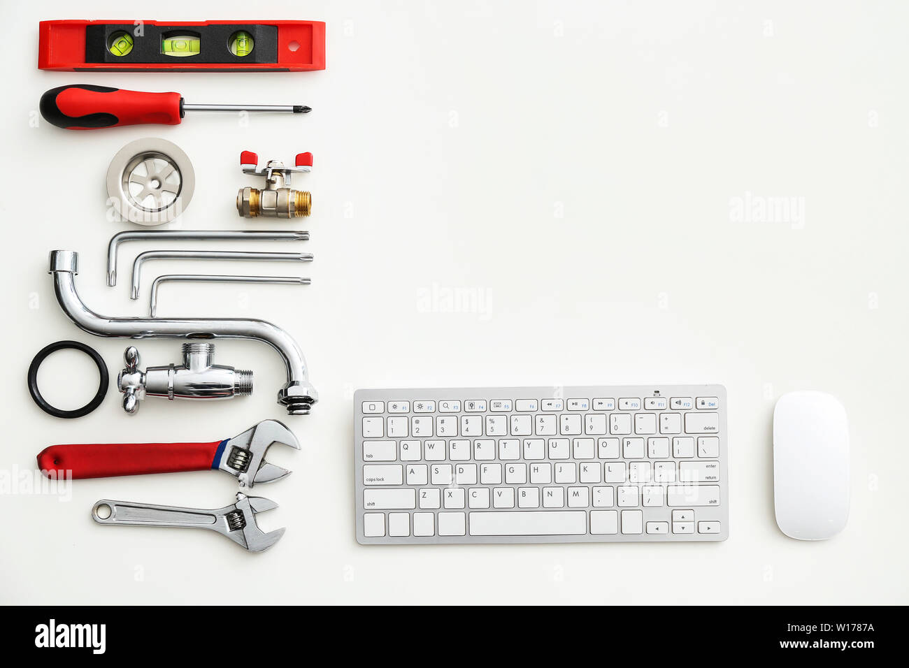Computer keyboard and plumbing items on white background Stock Photo ...