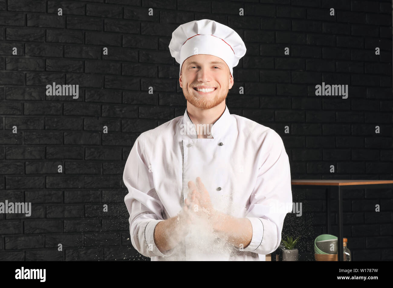 Male chef clapping hands with flour in kitchen Stock Photo - Alamy
