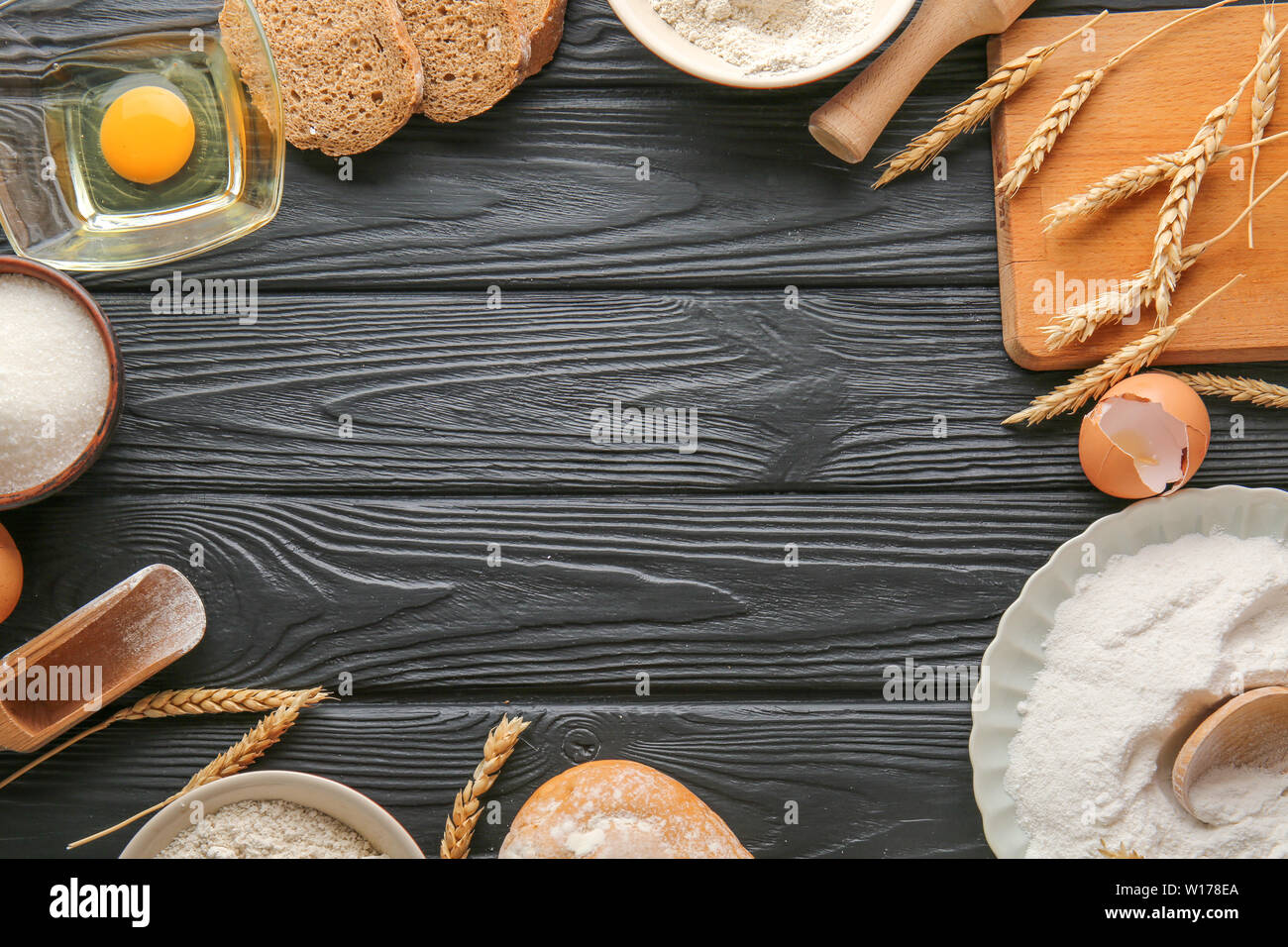 Frame made of flour and products on dark wooden background Stock Photo ...