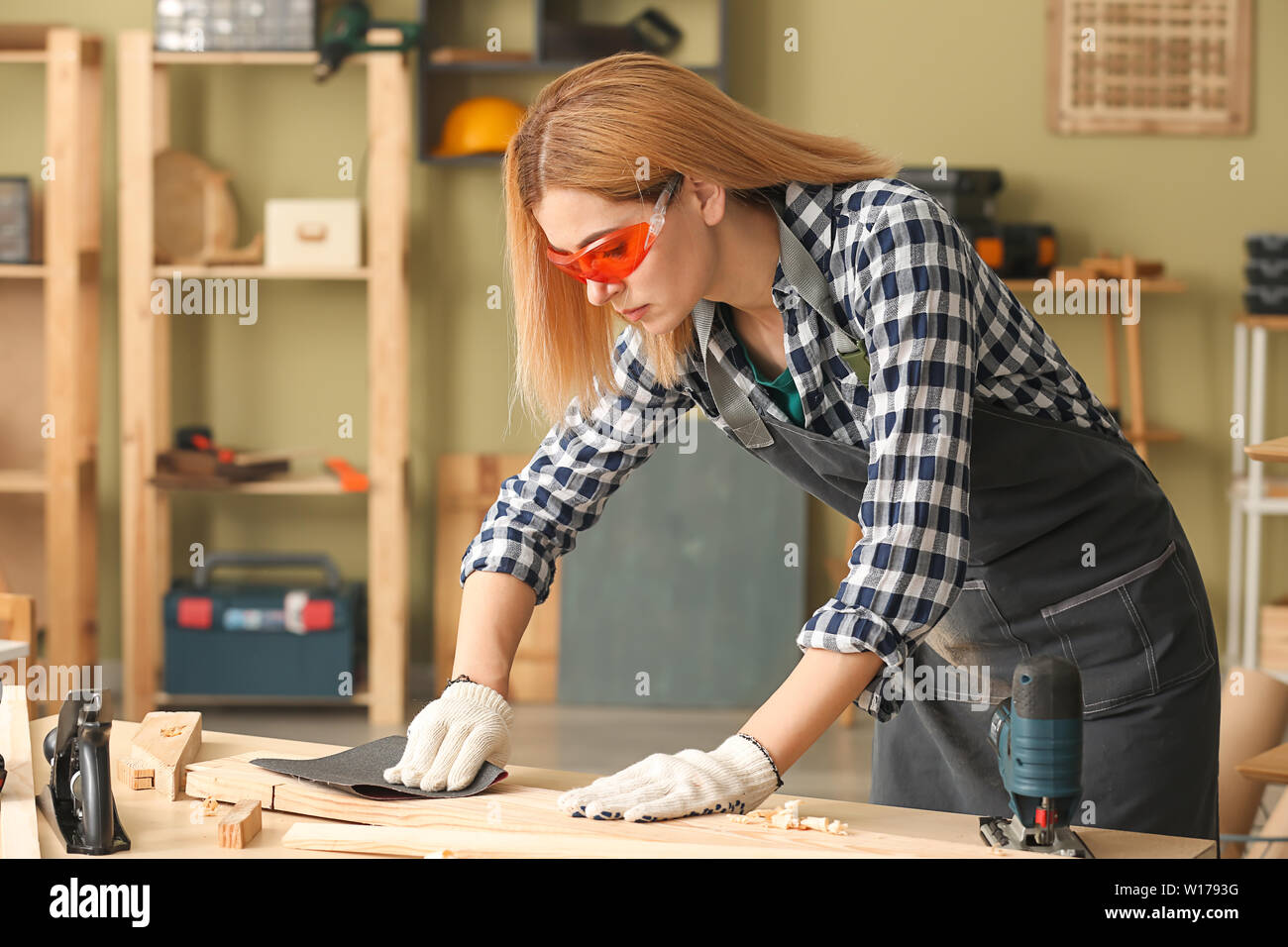 Female carpenter smoothing wooden hi-res stock photography and images ...