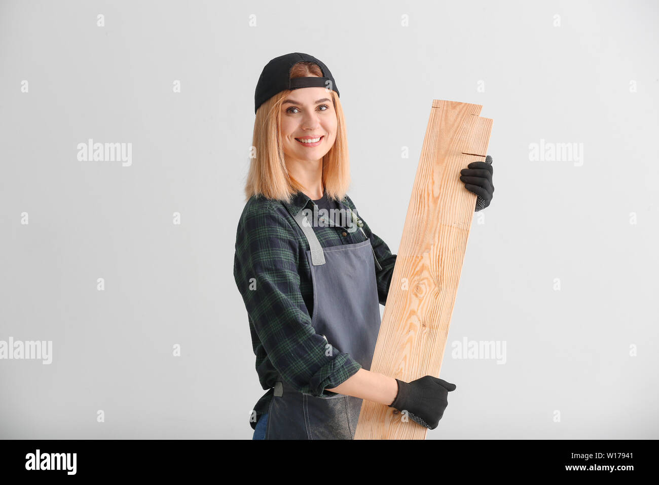 Female carpenter on light background Stock Photo - Alamy