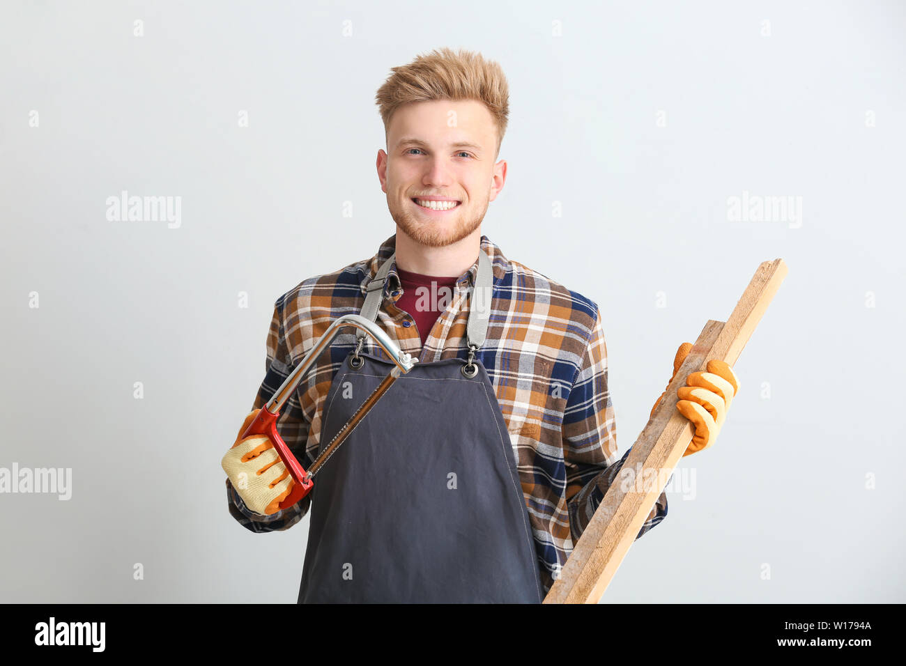 Male carpenter on grey background Stock Photo - Alamy