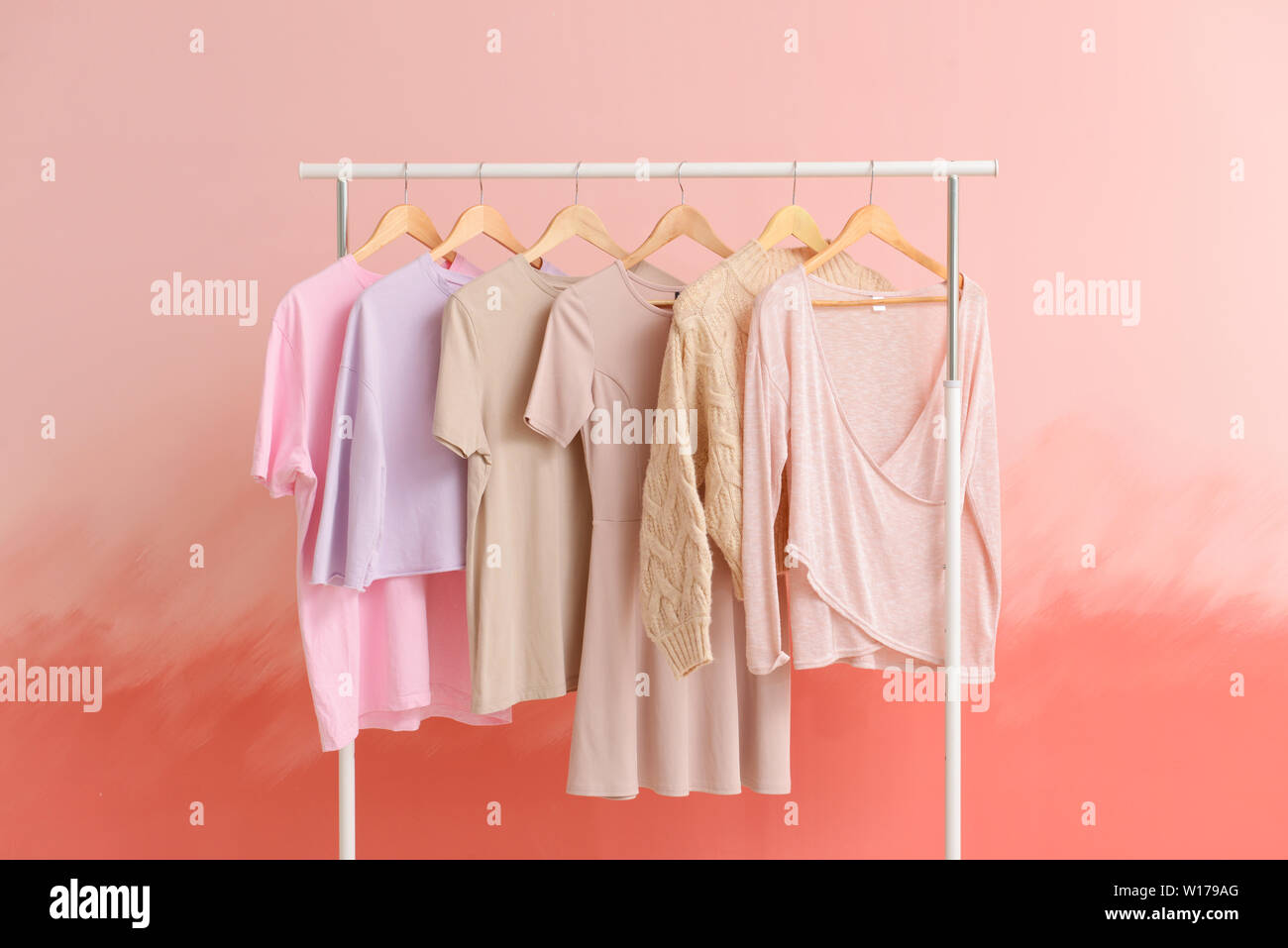 Rack with clothes after dry-cleaning on color background Stock Photo ...