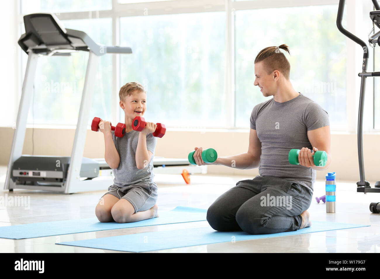 Father and son training together in gym Stock Photo - Alamy