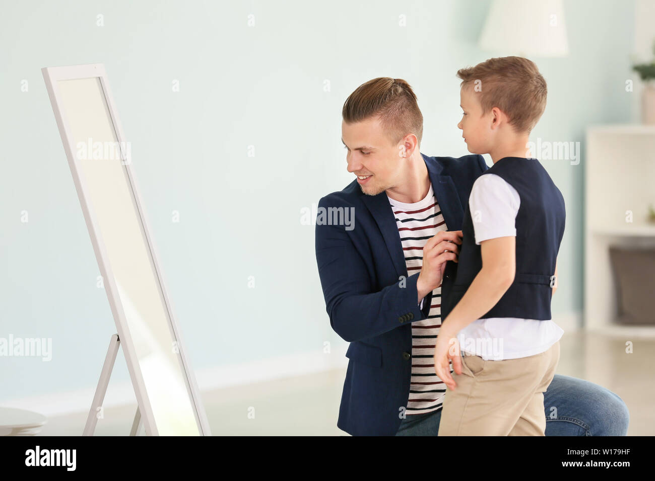 Father and son in fashionable clothes at home Stock Photo - Alamy