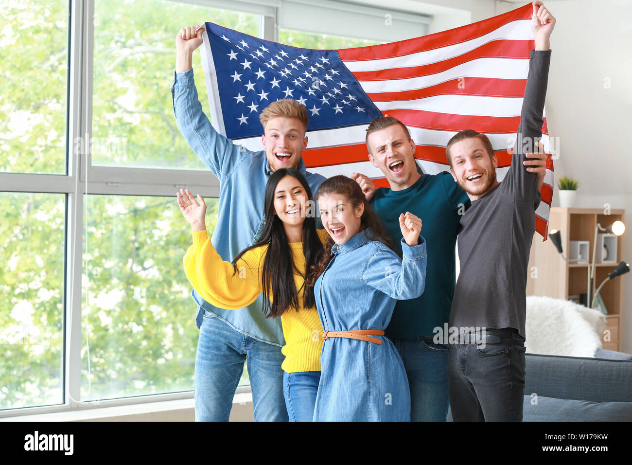 Happy friends with USA flag at home. Independence Day celebration Stock ...