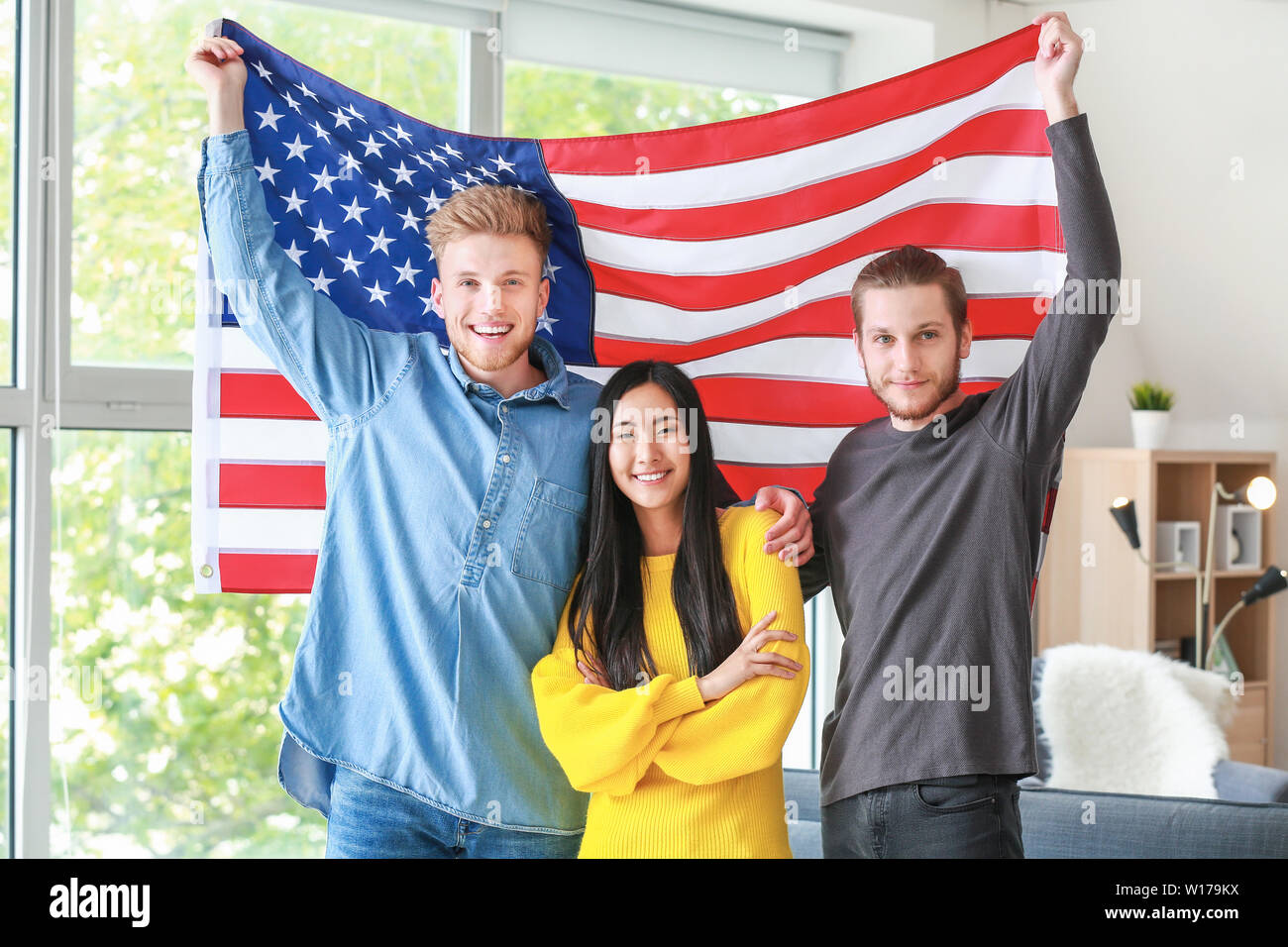 Happy friends with USA flag at home. Independence Day celebration Stock ...