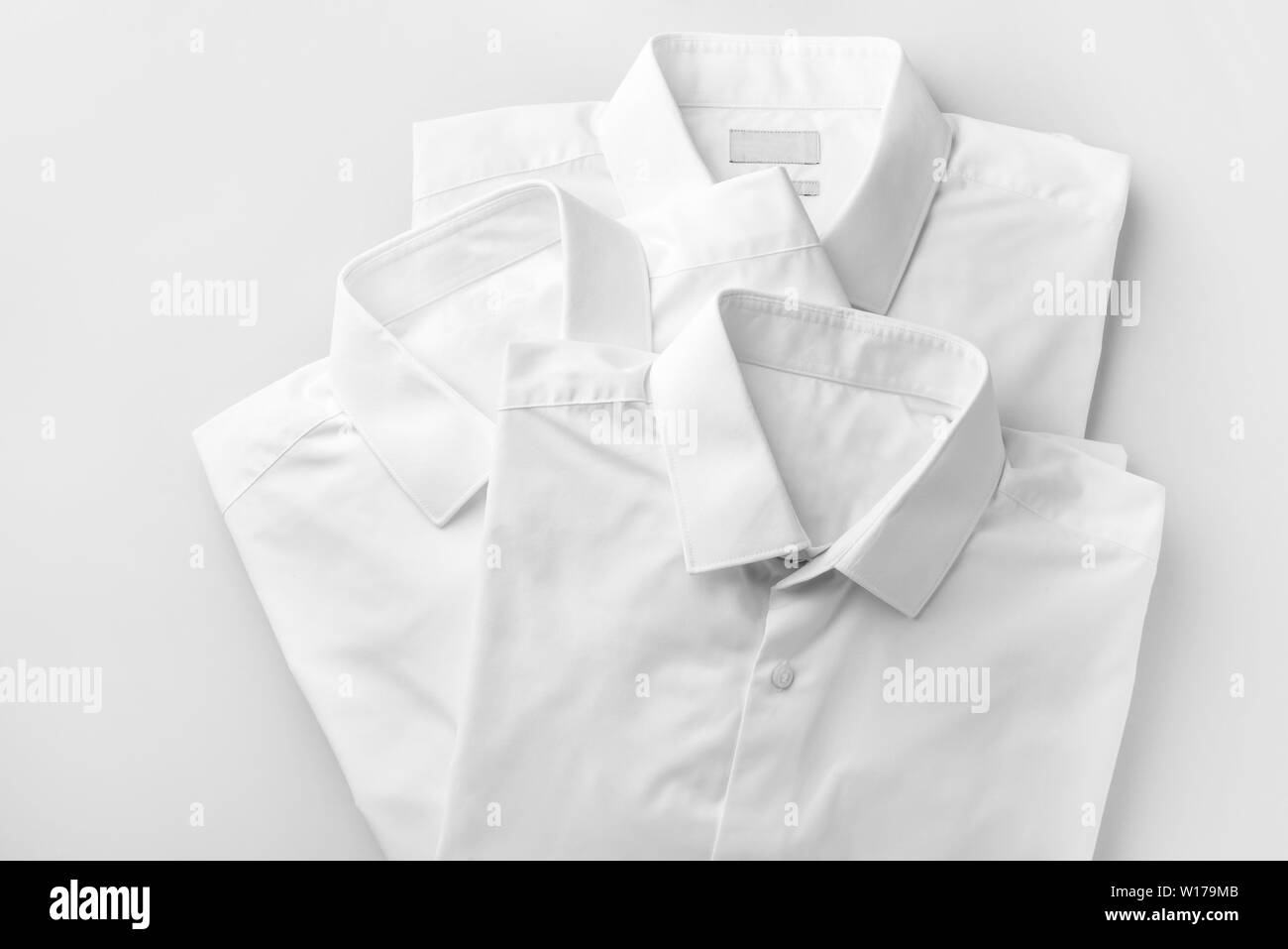 Shirts after dry-cleaning on light background Stock Photo - Alamy