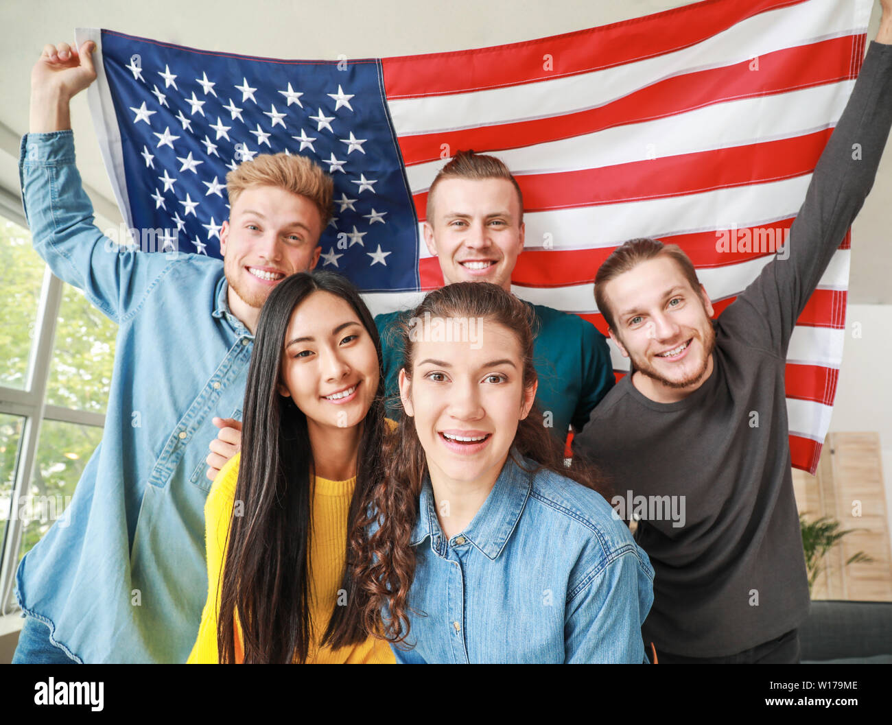 Happy friends with USA flag at home. Independence Day celebration Stock ...