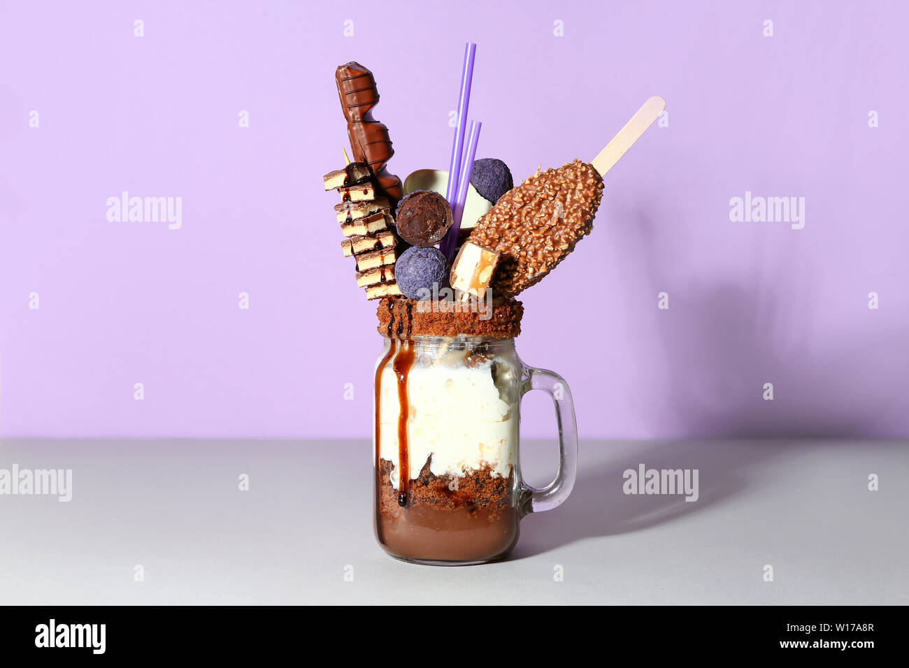 Mason jar with delicious freak shake on table Stock Photo - Alamy