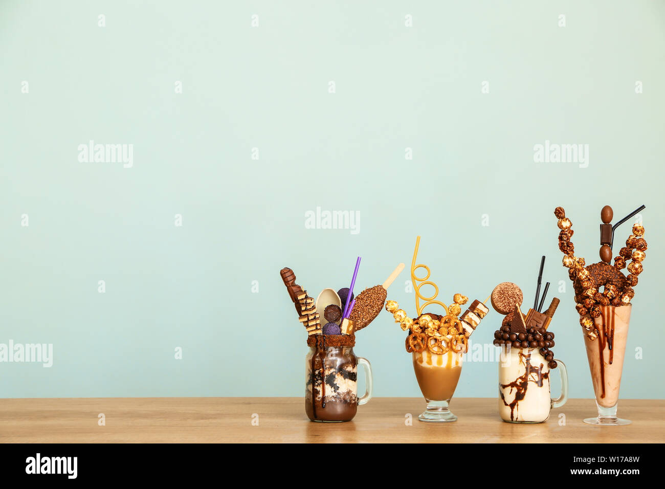 Delicious freak shakes on table against grey background Stock Photo - Alamy
