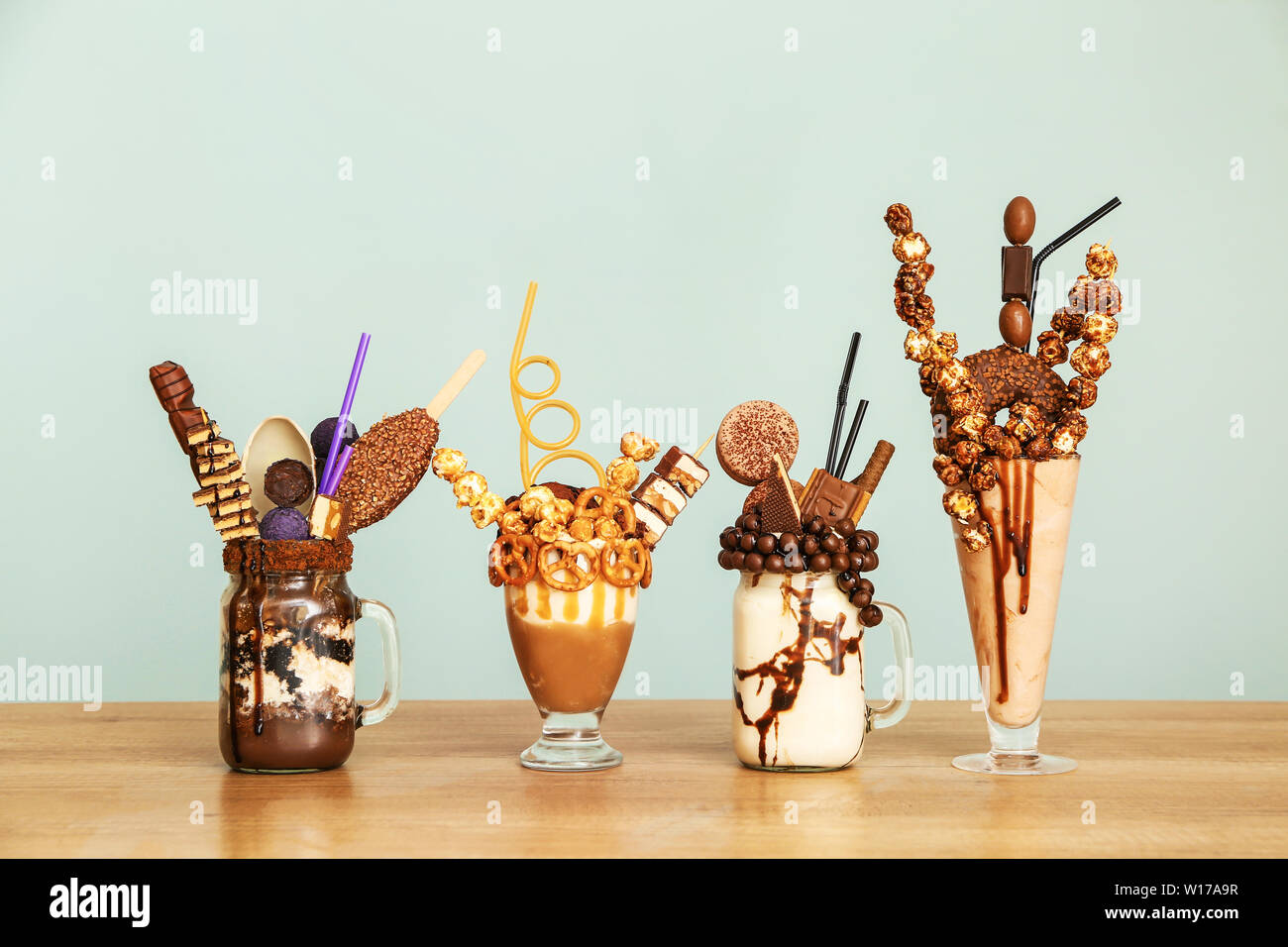 Delicious freak shakes on table against grey background Stock Photo - Alamy