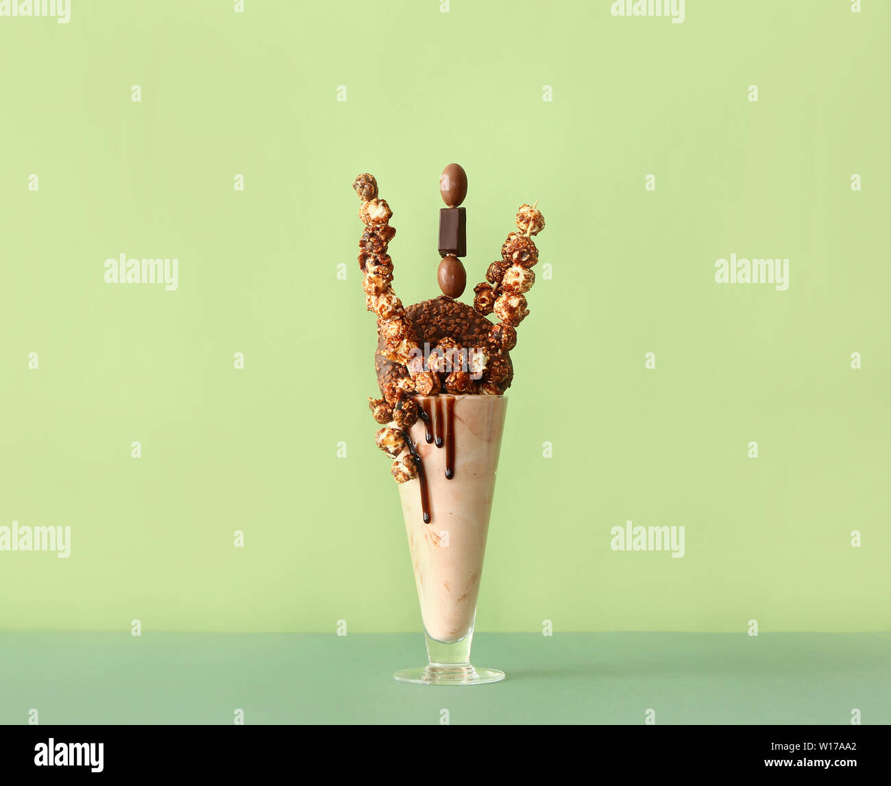 Glass with delicious freak shake on color background Stock Photo - Alamy