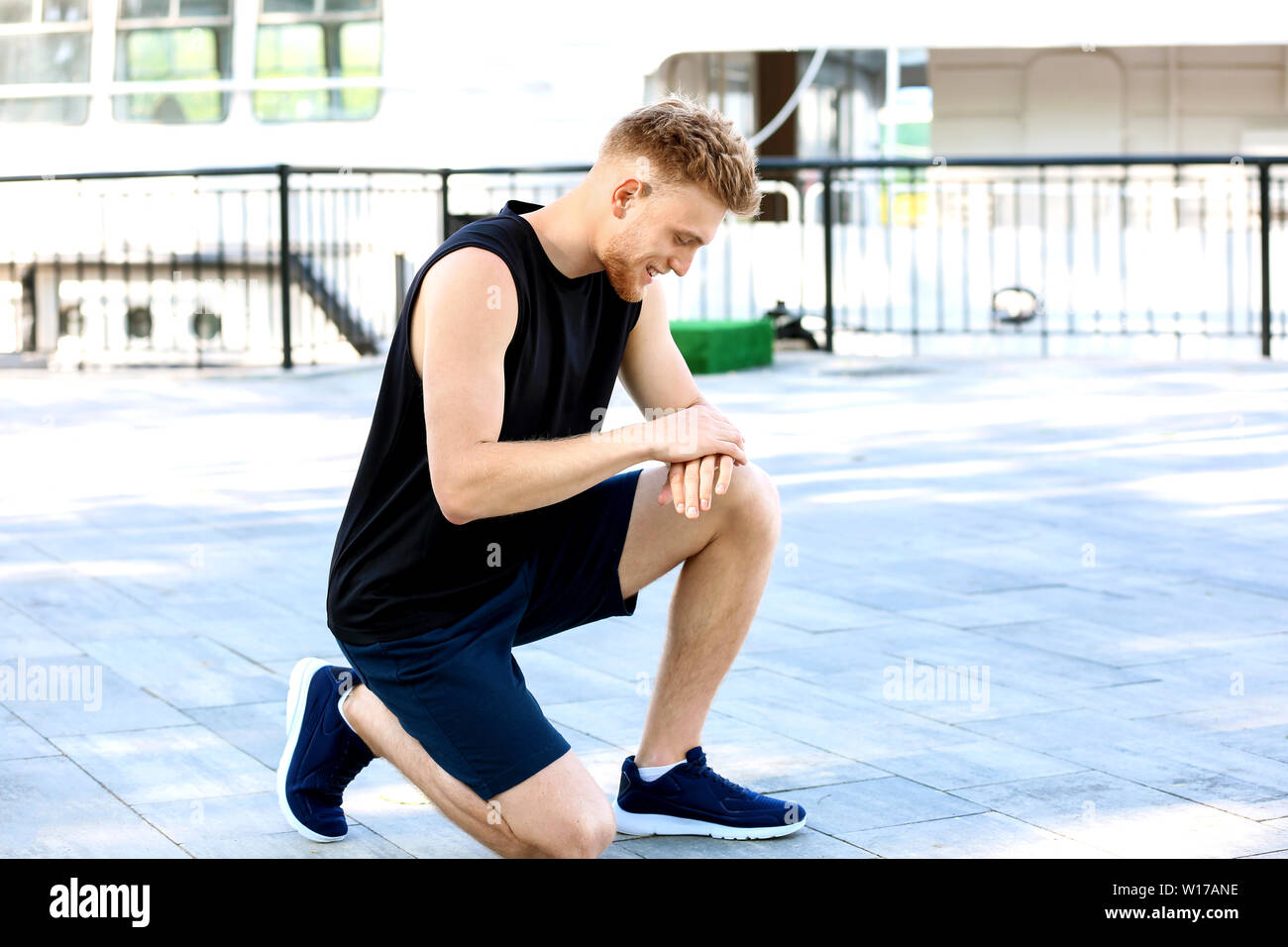 Sporty young man checking his pulse outdoors Stock Photo - Alamy
