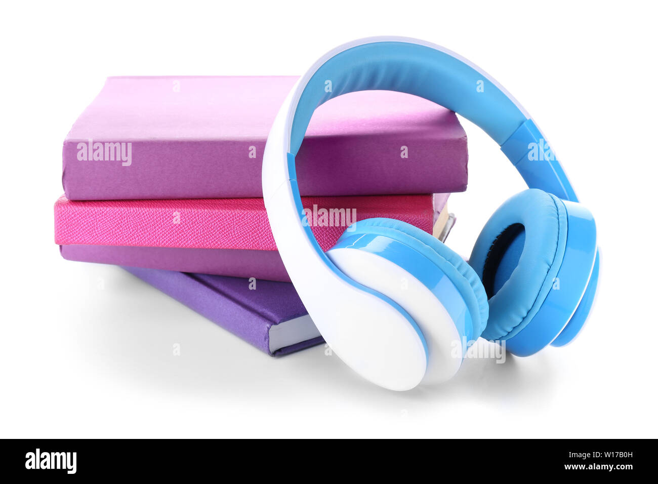 Books and modern headphones on white background. Concept of audiobook ...