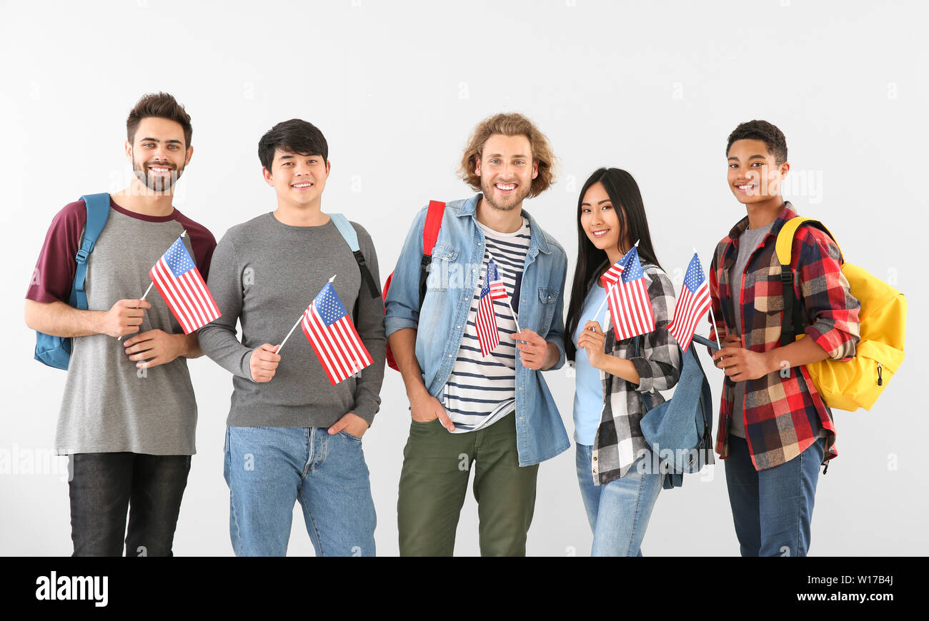 Group of students with USA flags on light background Stock Photo - Alamy