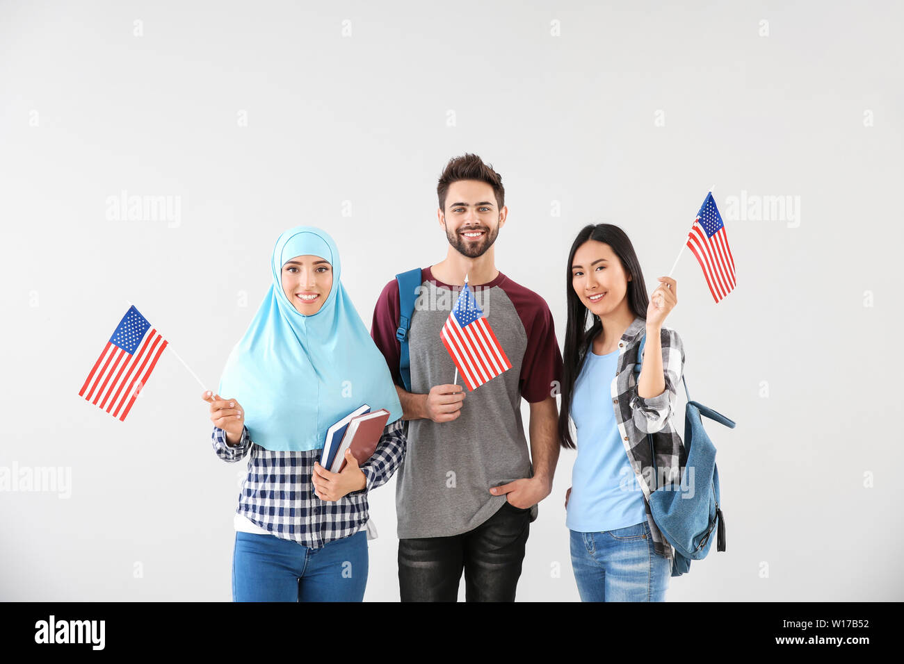 Group of students with USA flags on light background Stock Photo - Alamy