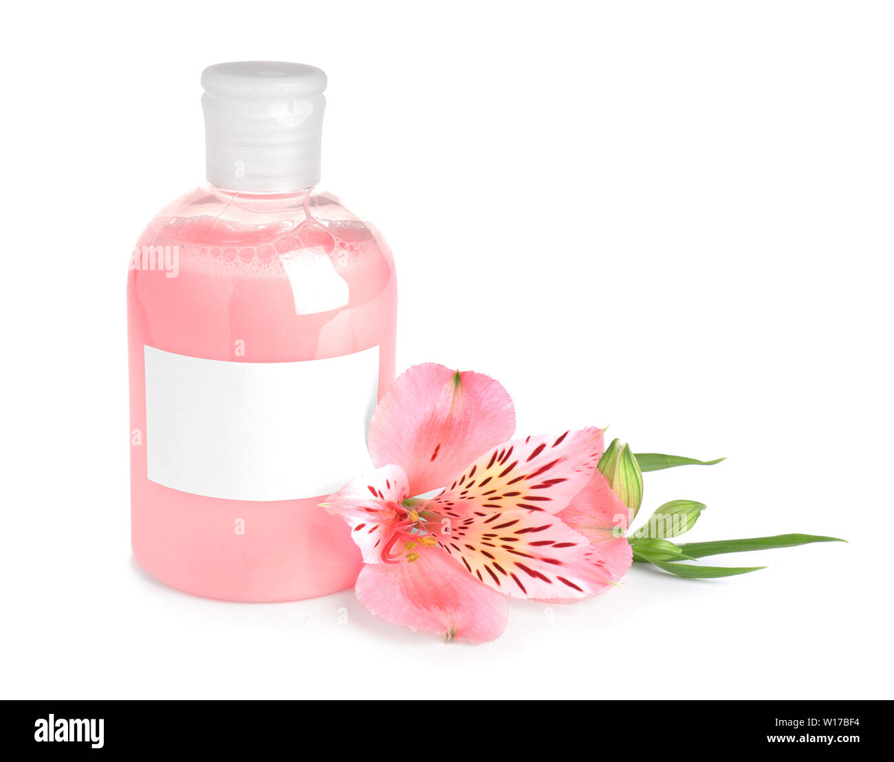 Bottle of shampoo and flower on white background Stock Photo - Alamy