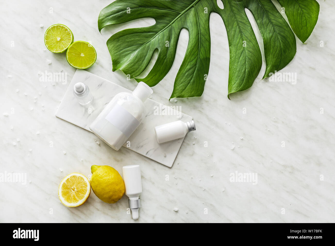 Shampoo, citrus fruits and tropical leaf on white background Stock ...