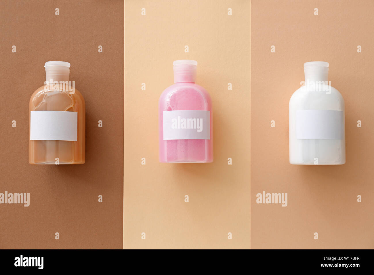 Bottles of shampoo on color background Stock Photo - Alamy