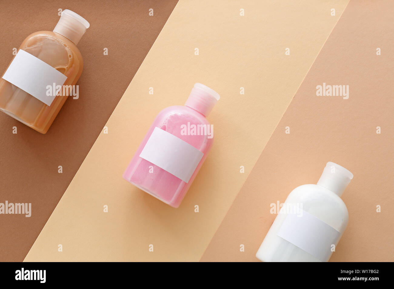 Bottles of shampoo on color background Stock Photo - Alamy