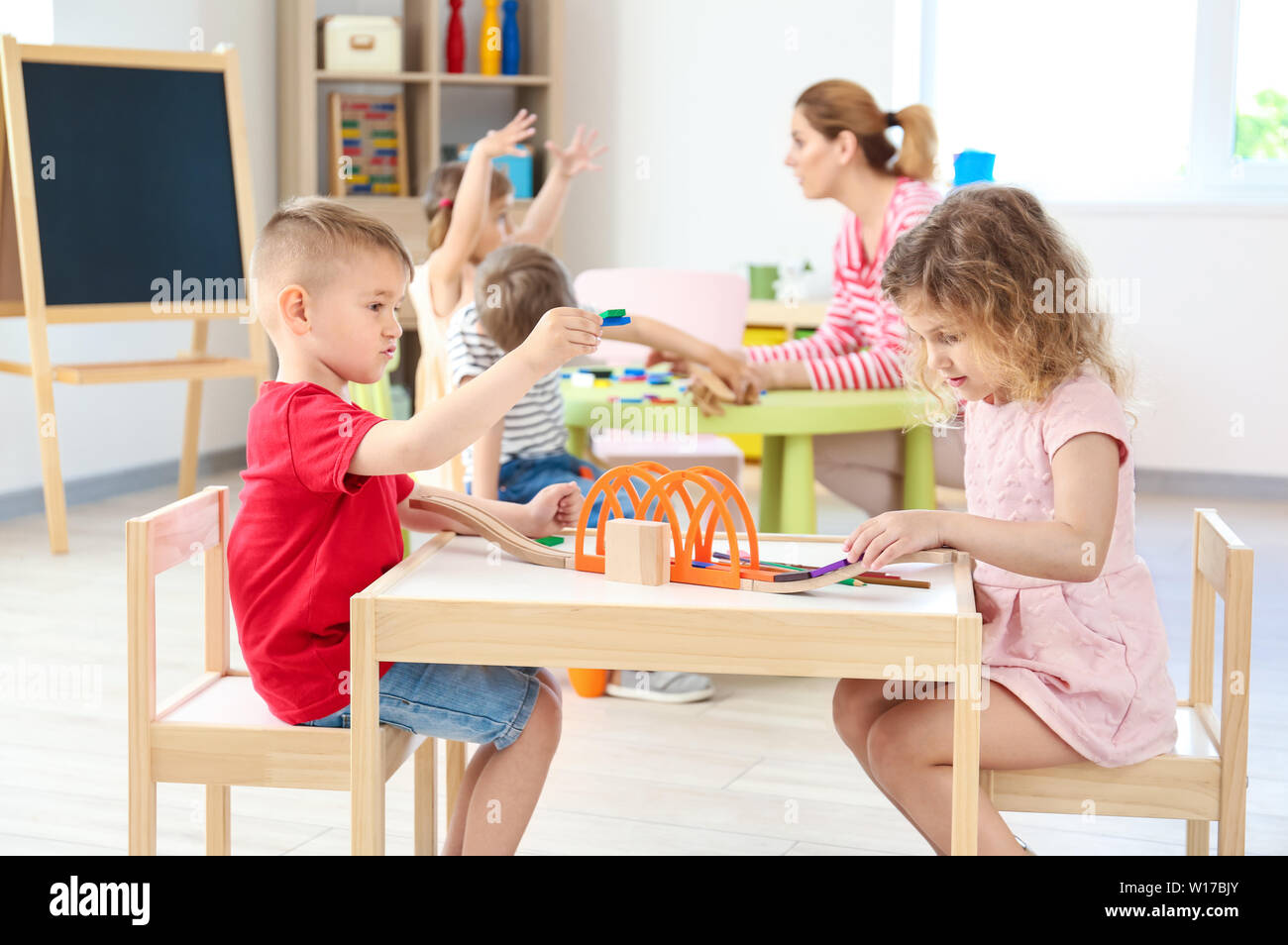Cute little children playing in kindergarten Stock Photo - Alamy