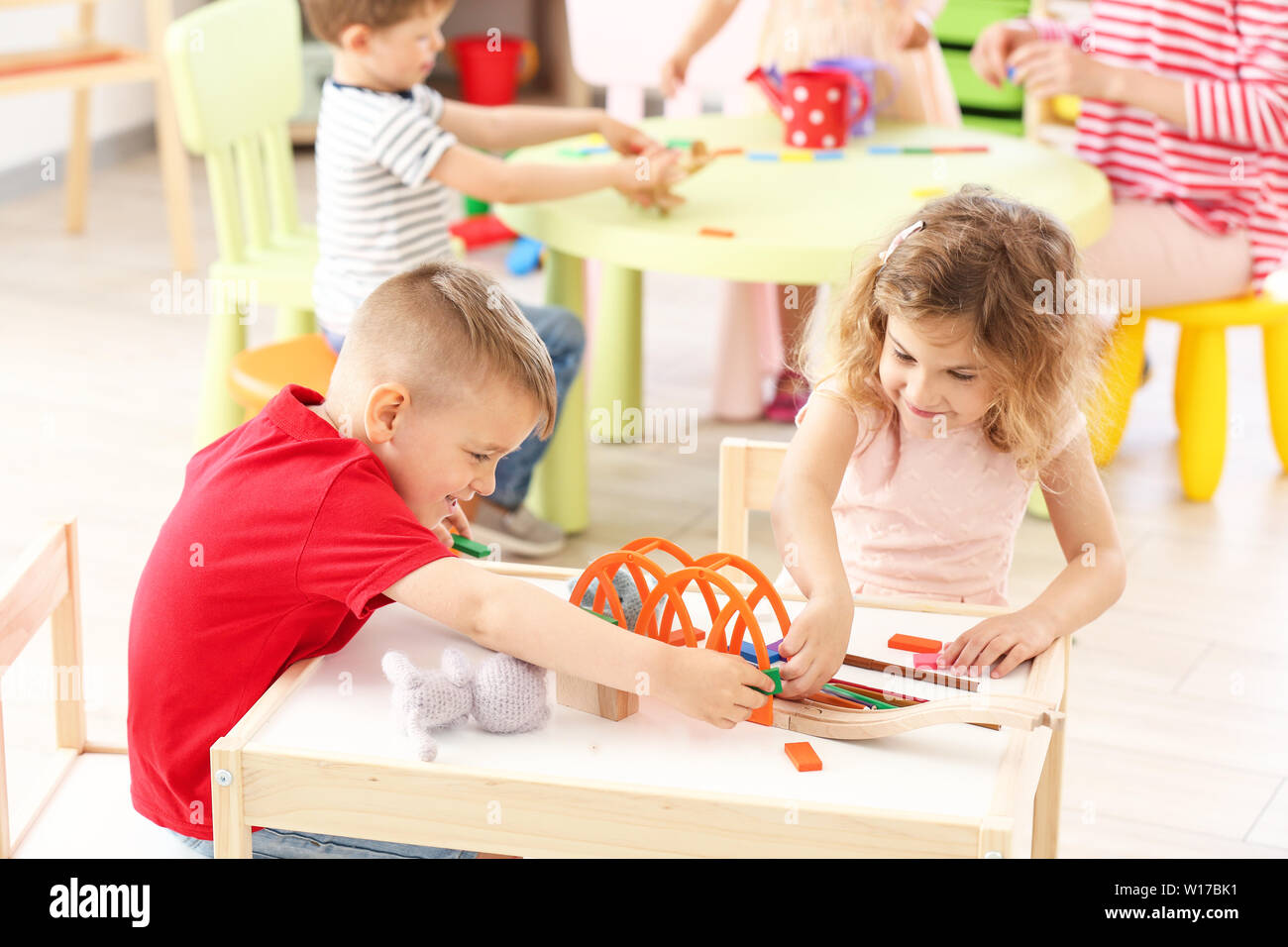 Cute little children playing in kindergarten Stock Photo - Alamy
